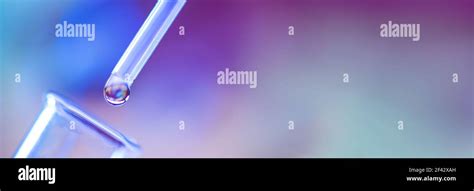 Close Up Of Chemical Test Tube And Pipette With Drop Of Colorless Liquid On Purple Background