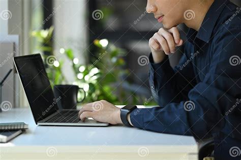 Concentrated Male Programmer Writing Program Code On Laptop Computer In