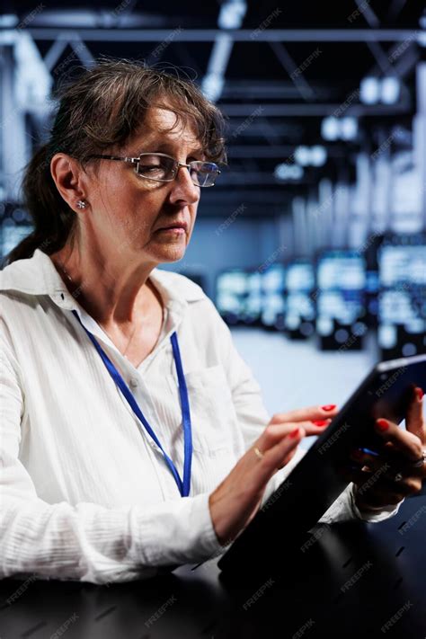 Premium Photo Octogenarian Admin Using Tablet To Assess Server Cybersecurity Flaws Arising Due