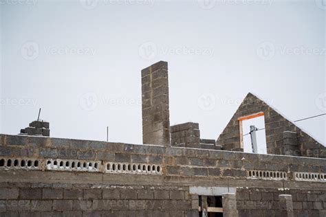A New Building Is Currently Being Constructed Using Bricks Along With Chimneys As Essential