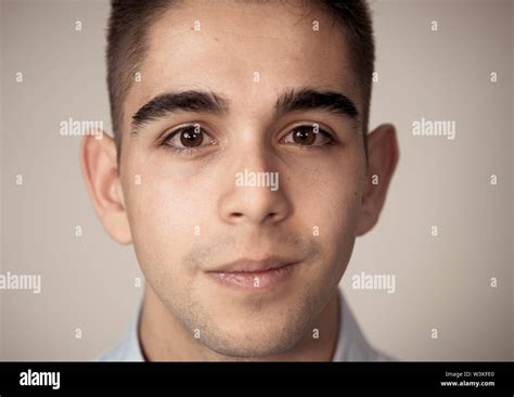 Close Up Portrait Of Attractive Confident Young Man Looking Neutral