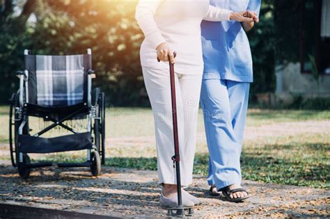 Asian Young Caregiver Nurse Support Senior Older Male Walking Outdoors Specialist Girl Doctor