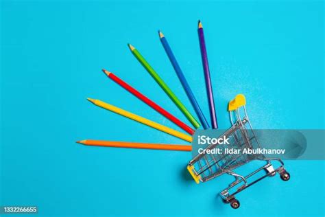 여러 가지 빛깔의 크레용과 파란색 배경에 쇼핑 카트 플랫 레이 학교로 돌아가는 개념 0명에 대한 스톡 사진 및 기타 이미지 0명 개념 개체 그룹 Istock