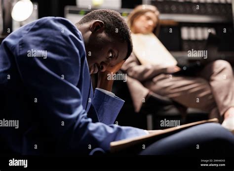 Tired Private Inspectors Checking Files With Crime Scene Evidence Discovering Confidential