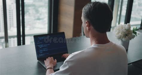 Software Engineer At Work As He Skilfully Crafts Code On His Laptop