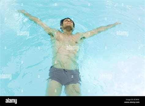 Man Floating On Back In Swimming Pool Stock Photo Alamy