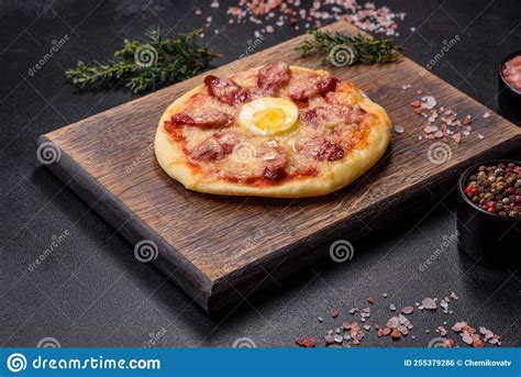 Homemade Pizza With Sausages Tomatoes Cheese Spices And Herbs On A