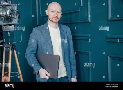 Portrait Of Attractive Adult Successful Bald Bearded Man In Suit With