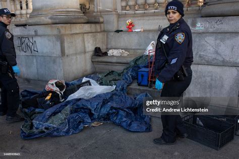 Police Officers And Sanitation Crews Force A Small Group Of Homeless