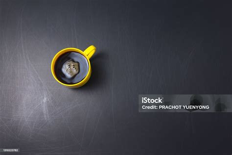 노란색 컵 시계 방향으로 저어 검은 커피의 머그잔은 거친 검은 배경에 누워 평평한 누워 텍스트 이미지 또는 메시지에 대한 공간을 복사합니다 최소한의 수평 이미지 스타일 0