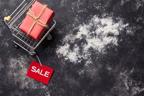 A Small Green Trolley Complete With A Mini Pushcart Loaded With Brightly Colored T Boxes