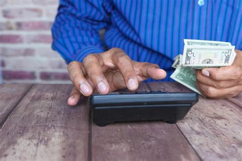 Premium Photo Close Up Of Man Hand Using Calculator