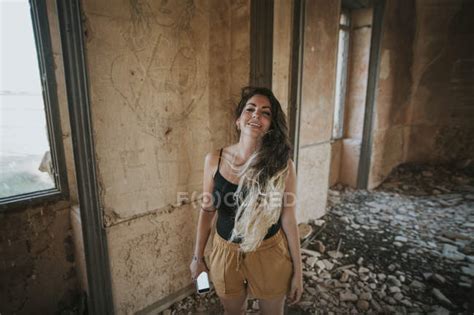 Cheerful Girl Posing At Abandoned Room — Looking At Camera Smartphone