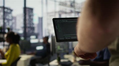 Data Scientist Uses Tablet To Check On Machine Learning Models That Can Analyze Data To Automate