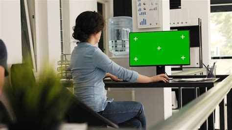 Premium Photo Office Worker Checks Greenscreen Monitor At Desk Working On Business Operations