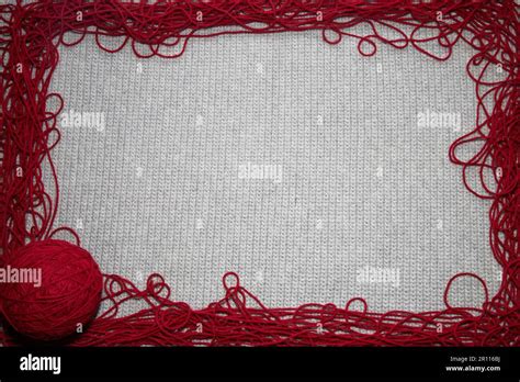 Top View Of Crocheted Gray Background With Red Yarn Border With A Place For Text For Yarn And