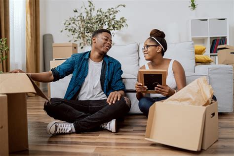 부부는 이사하는 과정에 그들은 천천히 물건의 골판지 상자를 포장 이야기 웃음 위치의 변화를 즐기고 논의 새로운 아파트에 앉아있다 2명에 대한 스톡 사진 및 기타 이미지