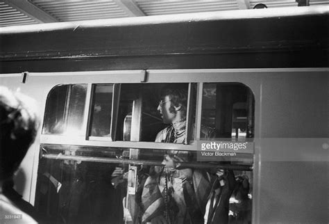 John Lennon Of The Beatles Standing By The Window Of A Train At
