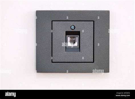 close up ethernet cable input on the wall socket input technology