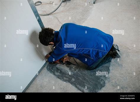 Construction Worker Using Machine Polishing Surface Floor Smoothing And