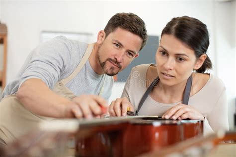 Male And Female Repairing Guitar Stock Photo Image Of Concept Parent