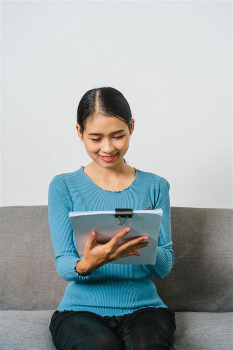 Premium Photo Young Asian Woman Working With Document Paper Files When Sitting On Couch