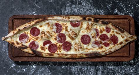 전통 터키 피데 일명 터키 피자 카샤르 치즈와 밀가루의 전체 검은 바닥에 나무 컷 보드에 터키어 소시지 0명에 대한 스톡 사진 및 기타 이미지 Istock