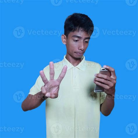 Excited Asian Man Wearing Yellow T Shirt Giving Number 12345 Hand