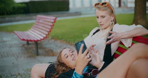 Woman Using Smart Phone While Lying On Friend S Lap Stock Footage Video Of Bench Mobile