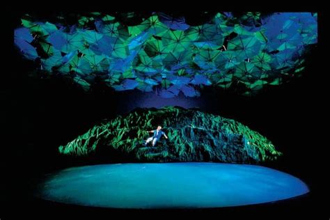 An Image Of A Man Standing On Top Of A Hill In The Middle Of The Night