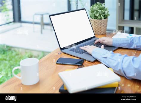 A White Screen Laptop Computer Placed On The Desk At Work Can Put Text Or Media In The Area On