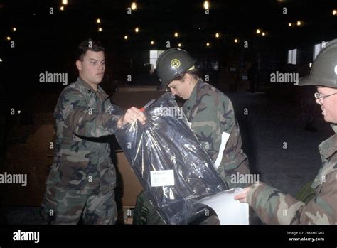 Yeoman Second Class Yn2 Clyde Lusk Hands Out Cold Weather Gear To