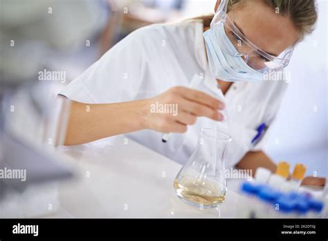 Careful Meticulous Work A Young Scientist Conducting An Experiment In