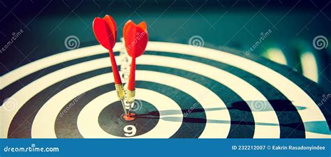 bullseye or bulls eye target or dartboard has dart arrow throw hitting