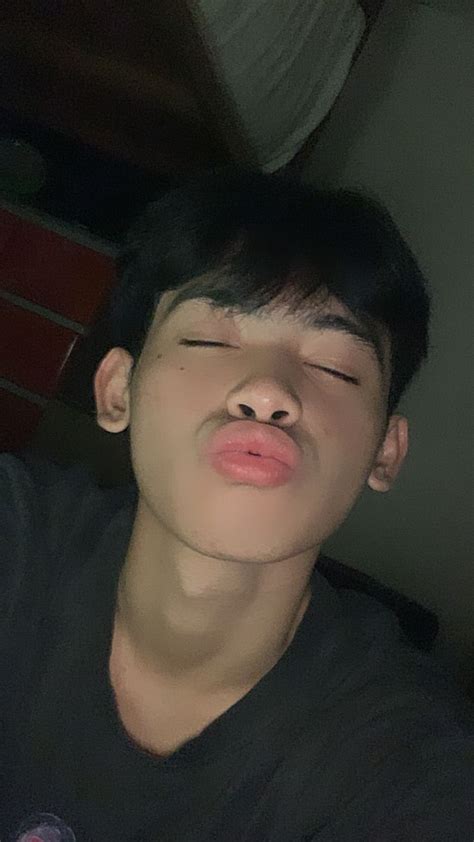 A Young Man With His Eyes Closed Is Taking A Selfie