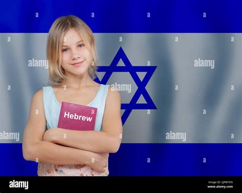 Cute Blonde Teen Girl Embracing Book With Inscription Hebrew In Hebrew