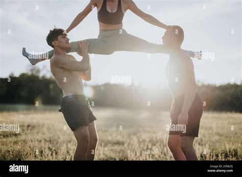 Flexible Girl Doing Front Split Exercise On Her Male Friend S Shoulders