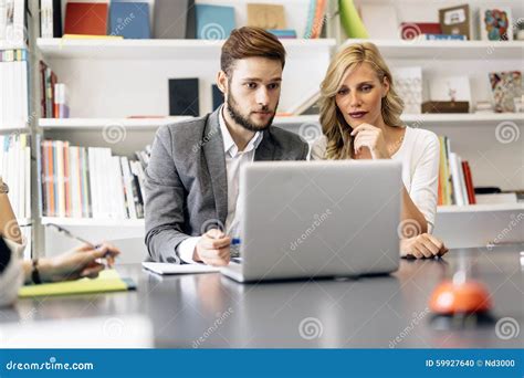 Two Colleagues Solving Problem On Laptop Stock Photo Image Of Colleagues Device