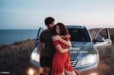 젊은 커플 남자와 여자는 일몰 후 해변에서 Suv 자동차 근처에서 포옹 함께 순간을 즐기는 연인 2명에 대한 스톡 사진 및 기타 이미지 Istock