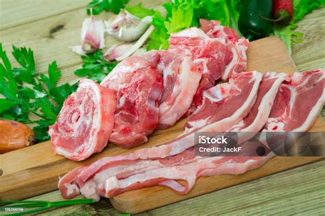 Fresh Slices Of Mutton And Vegetables Assortment On Natural Wooden Desk