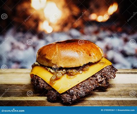 Smashed Cheeseburger On A Wooden Table In Front Of A Fireplace Stock
