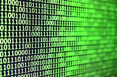 macro shot of binary code on the monitor of an office computer the