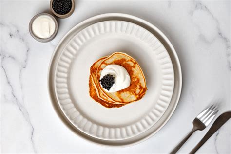 흰색 접시에 사워 크림 홀리데이 모닝 애피타이저가 있는 팬케이크의 블랙 캐비어와 포크와 칼이 있는 대리석 배경 위쪽 보기 접시에 대한 스톡 사진 및 기타 이미지 Istock