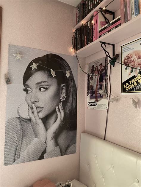 A Bedroom With Pink Walls And Pictures On The Wall Including A White Headboard
