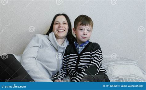 Watching TV Lying On The Couch Mom And Son Watch TV Together And Smile Stock Footage Video