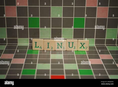 Wooden Tile With Green Linux Text On A Blocked Background Stock Photo Alamy