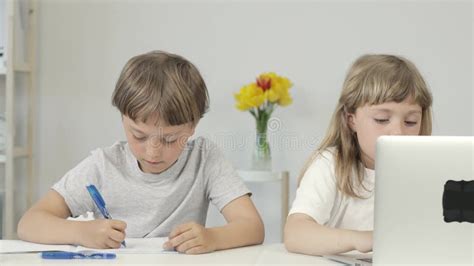 Brother Helps His Younger Sister To Make Her Homework Stock Footage