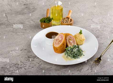 Cordon Bleu With Ham Cheese Cream Spinach And Smashed Potato At White