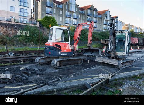 Two Small Tractor Diggers Parked Up Used In Small Scale Track Repairs In Bristol Old City Center
