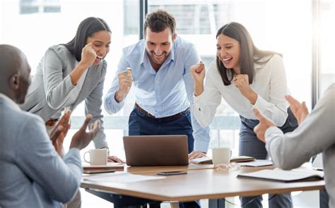 We Can Do This Shot Of A Group Of Businesspeople Cheering While Using